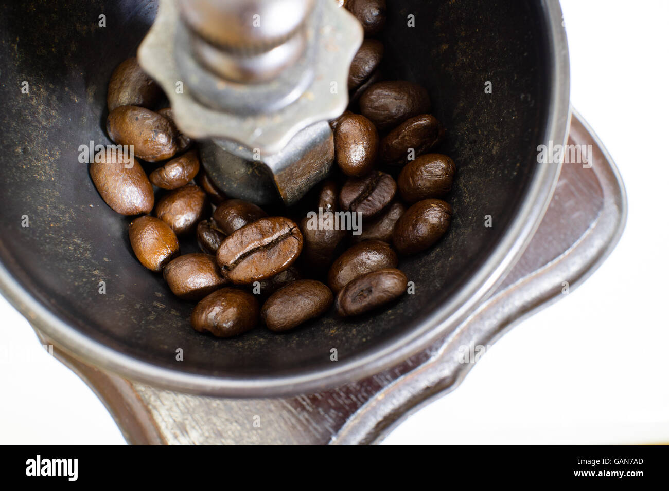 Old fashioned hand mill with coffee beans Stock Photo - Alamy
