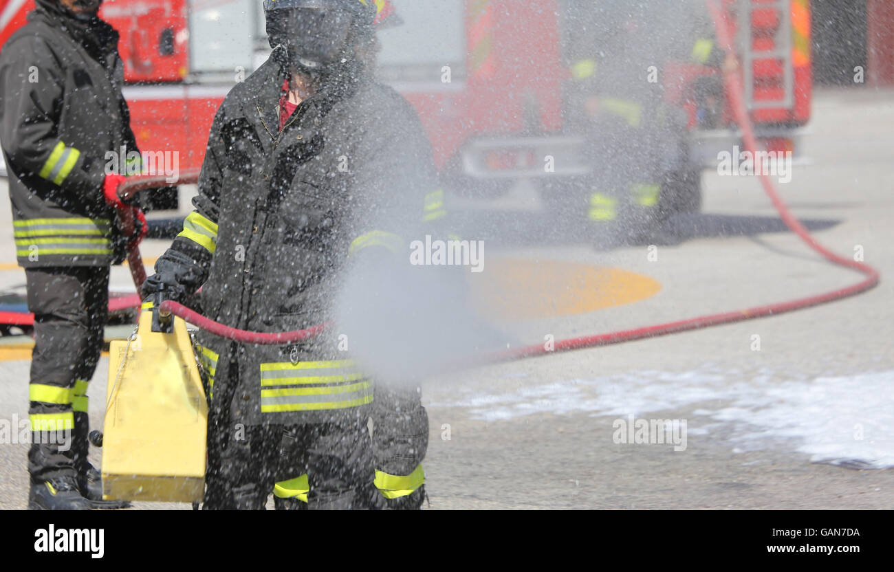 firefighters with the fire extinguisher during a practice session at ...