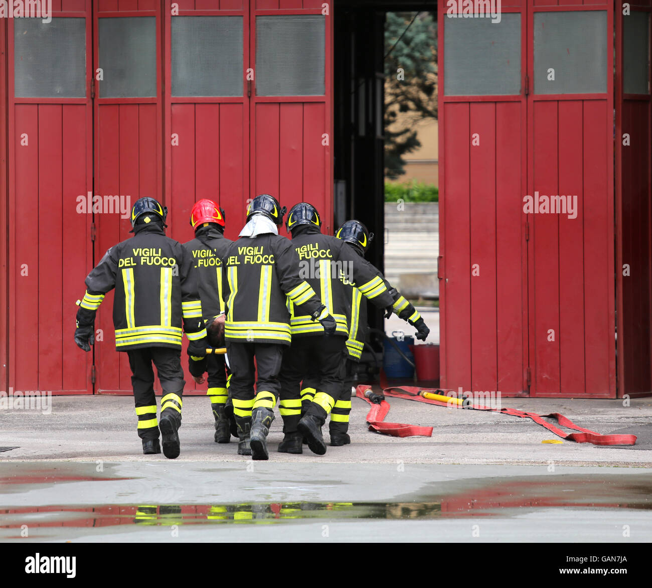 wounded person carried by firefighters on a stretcher during training ...