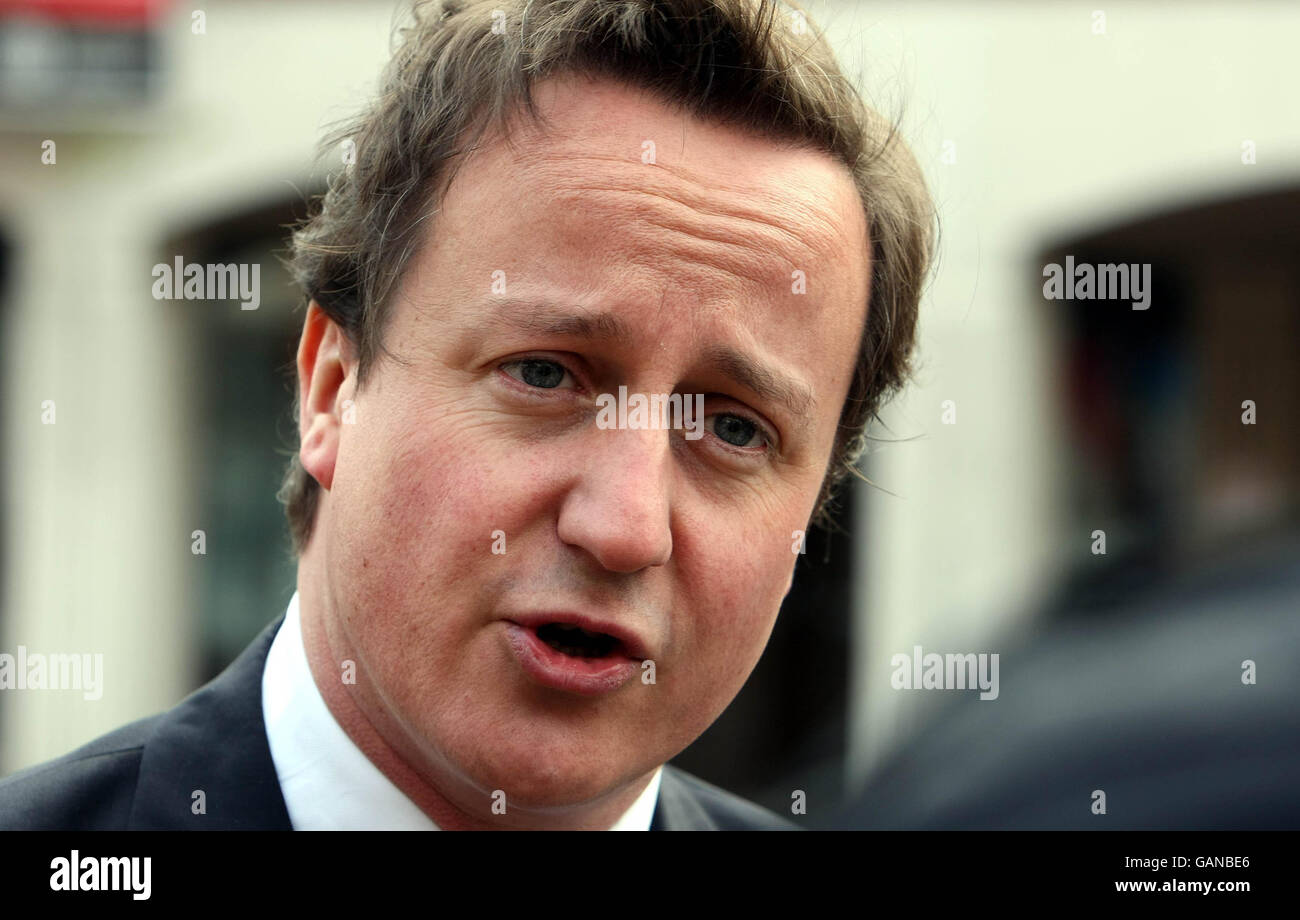 Conservative leader David Cameron talks to commuters at a bus stop in ...