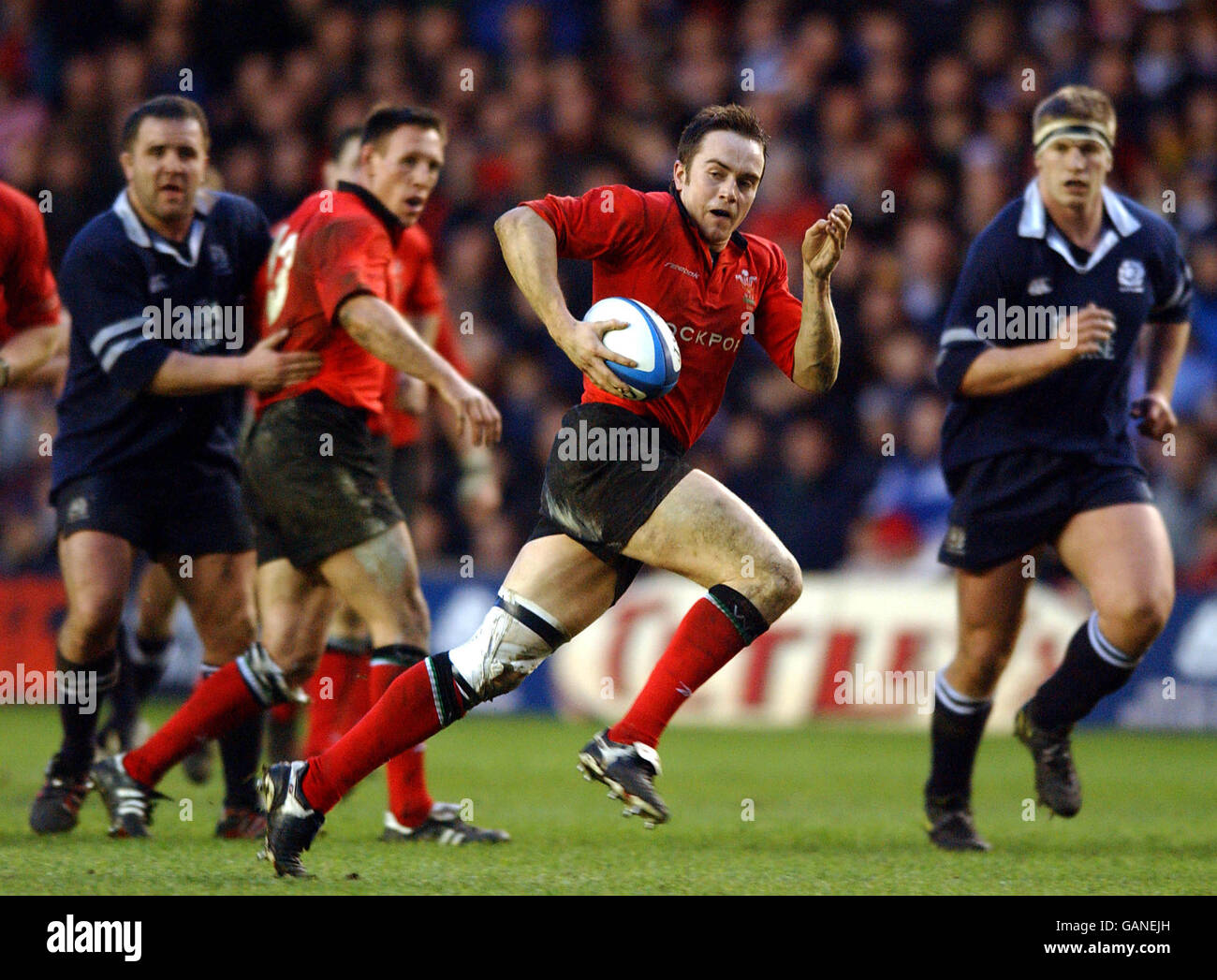 Wales' Matthew Watkins on his way to scoring a late try against ...