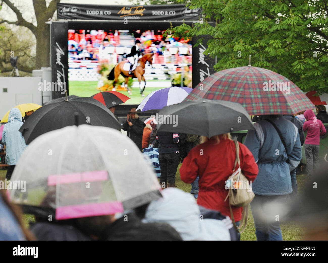 Spectators under umbrellas as the rain falls at the Mitsubishi Motors ...