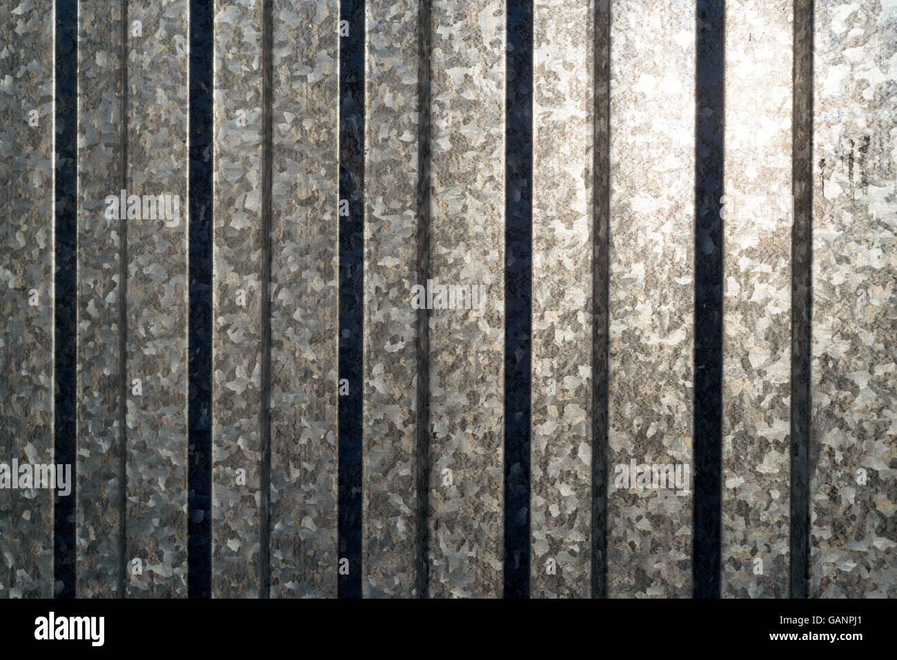 Aluminum sheeting in vertical with sunlight reflecting off the metal ...