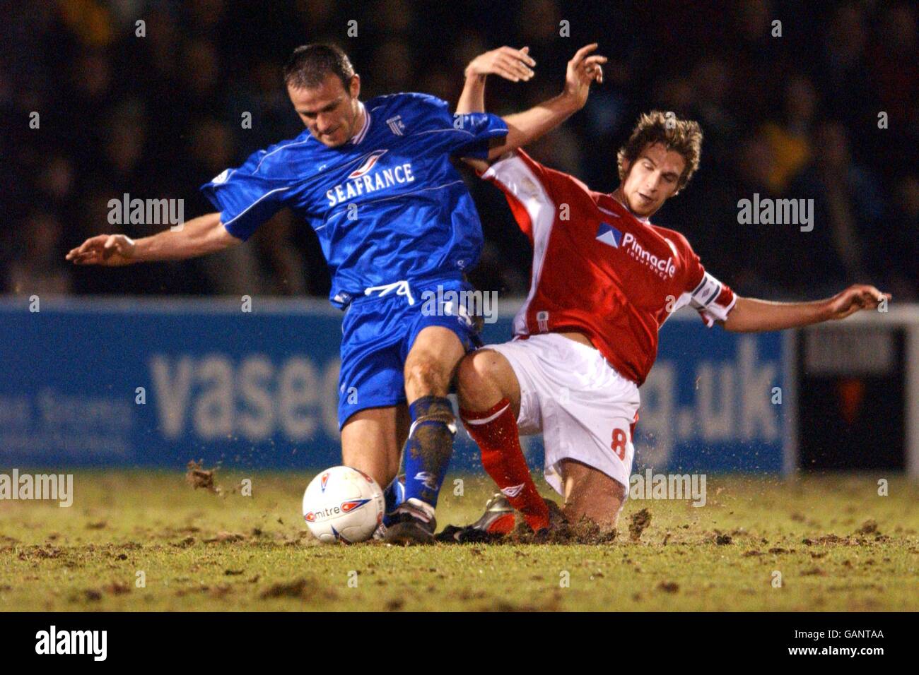 Gillingham's Mark Saunders battles for possession of the ball with ...