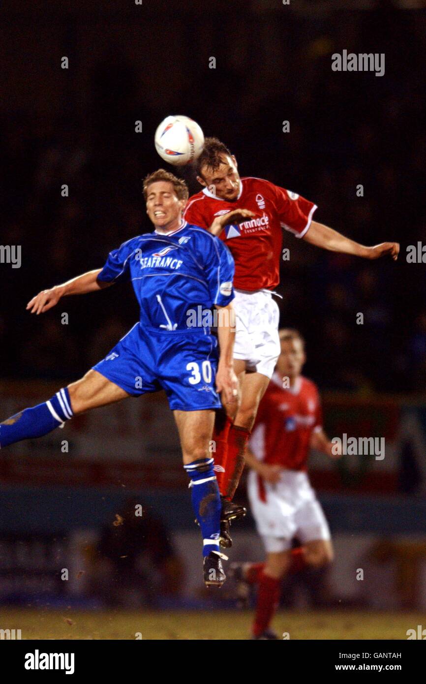 Gillingham's Nicky Southall jumps for the ball in the air with ...