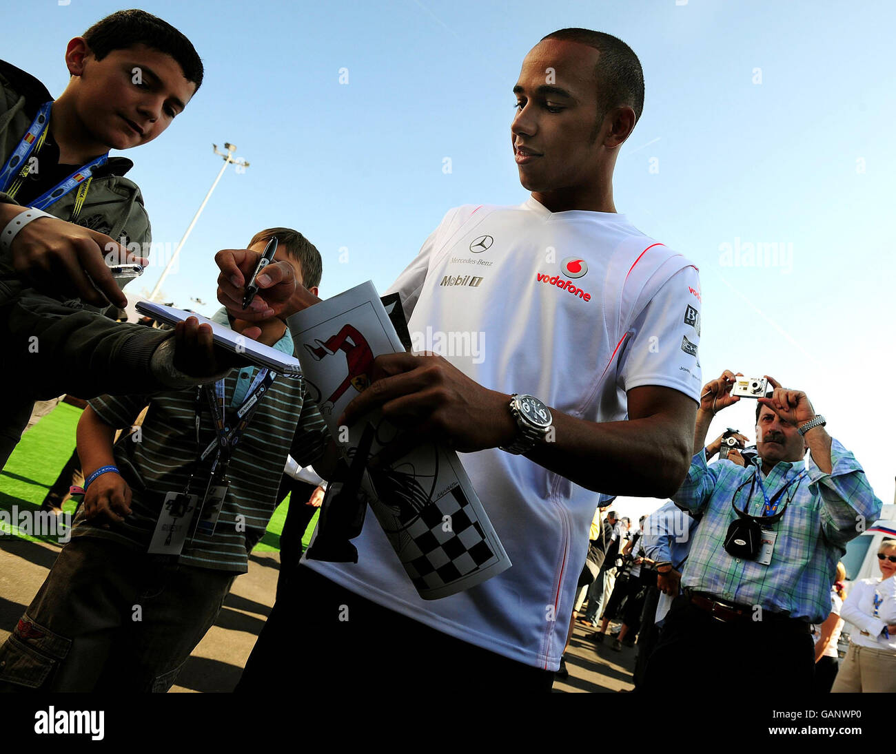 Great Britain's Lewis Hamilton signs autographs for fans before the ...