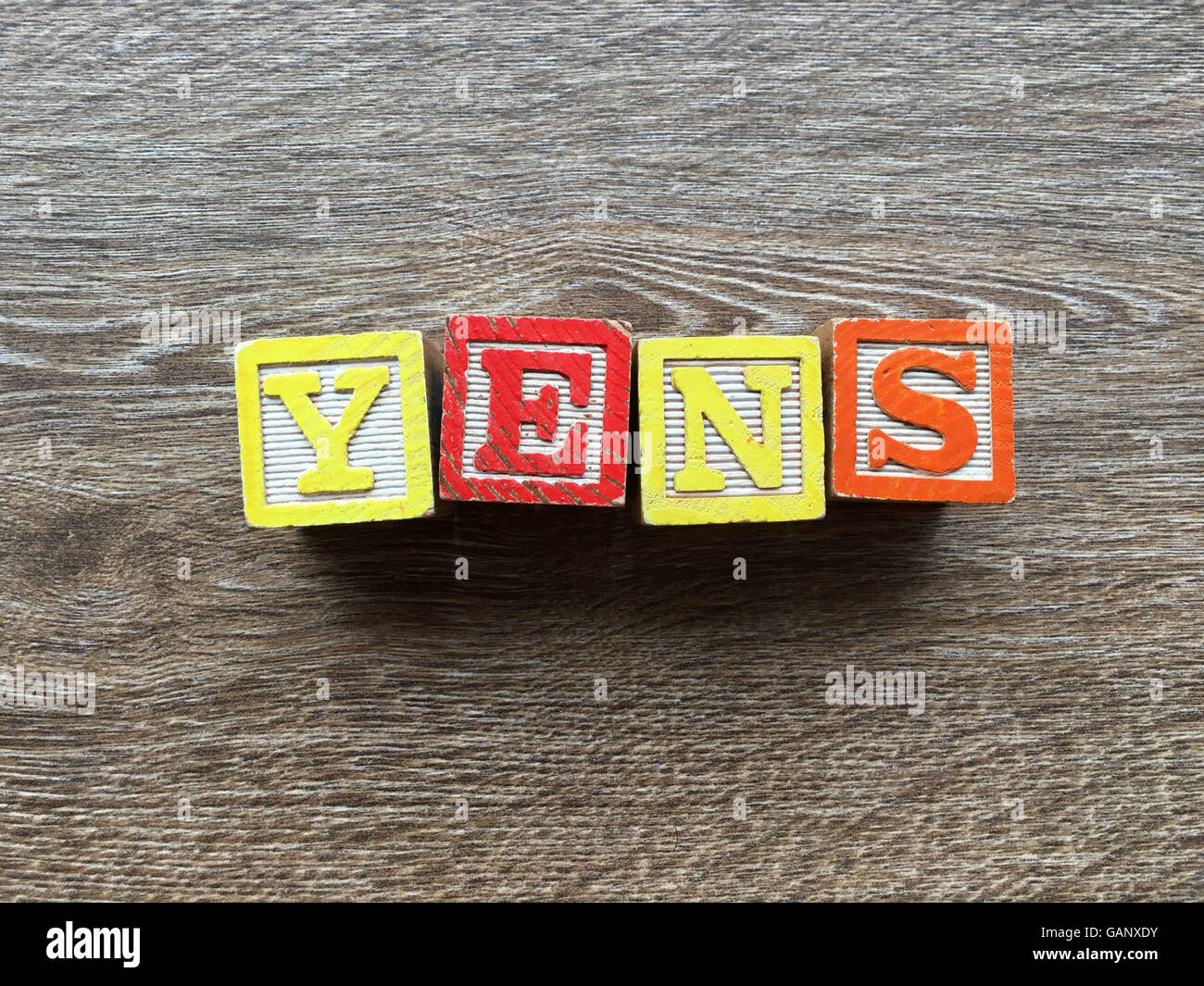 YENS word made with toy wood blocks letters Stock Photo - Alamy