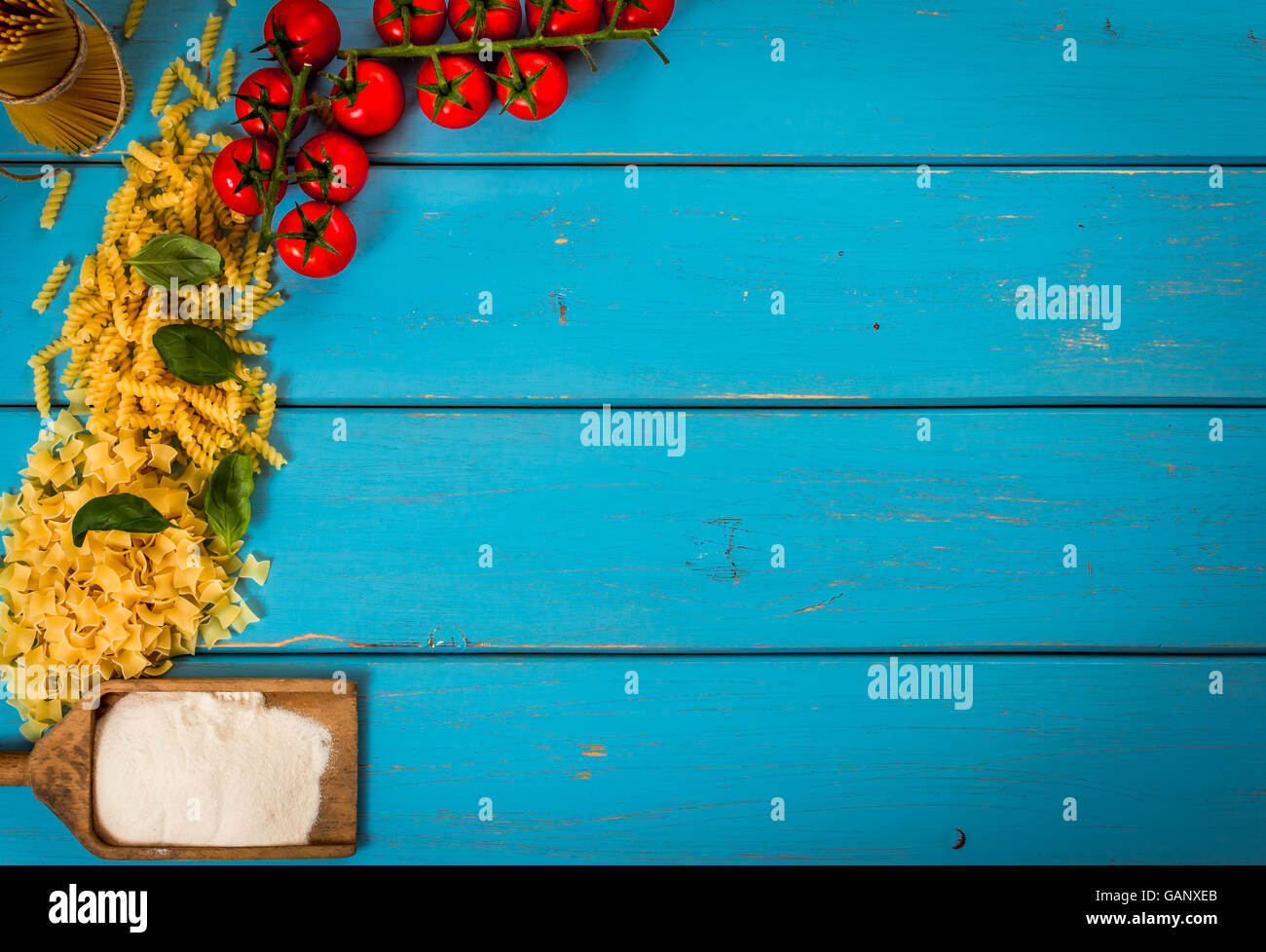 Food or cooking background with pasta, tomato, spaghetti, penne, basil ...