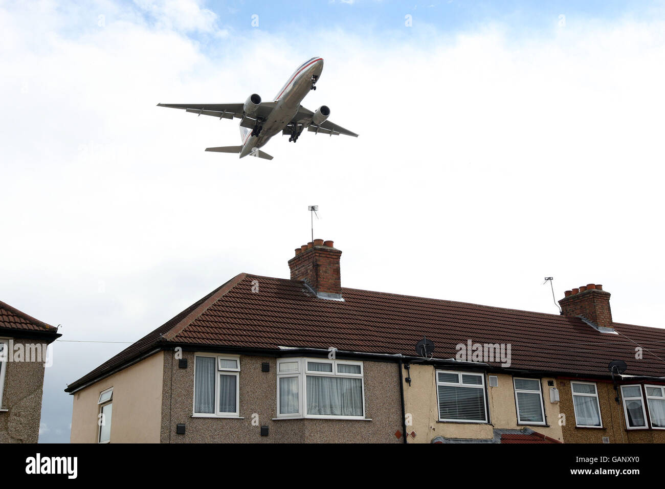 A generic photograph of a plane flying low over a local housing estate ...