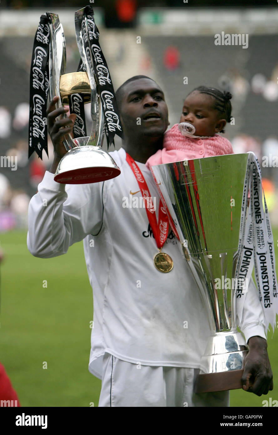 Milton Keynes Dons' Jude Stirling lifts the League Two Trophy as his ...
