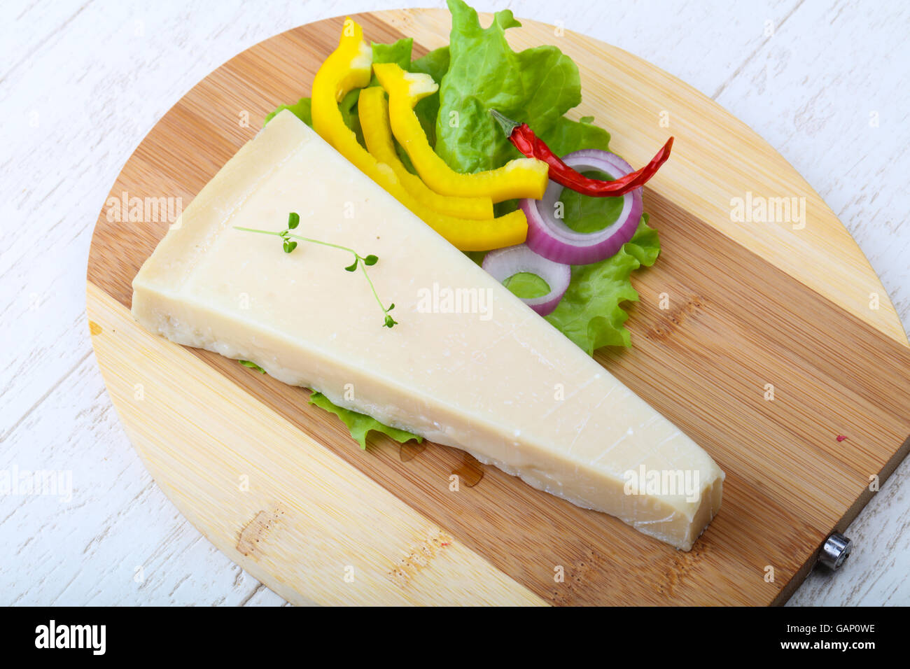 Parmesan cheese triangle on the wood background Stock Photo - Alamy
