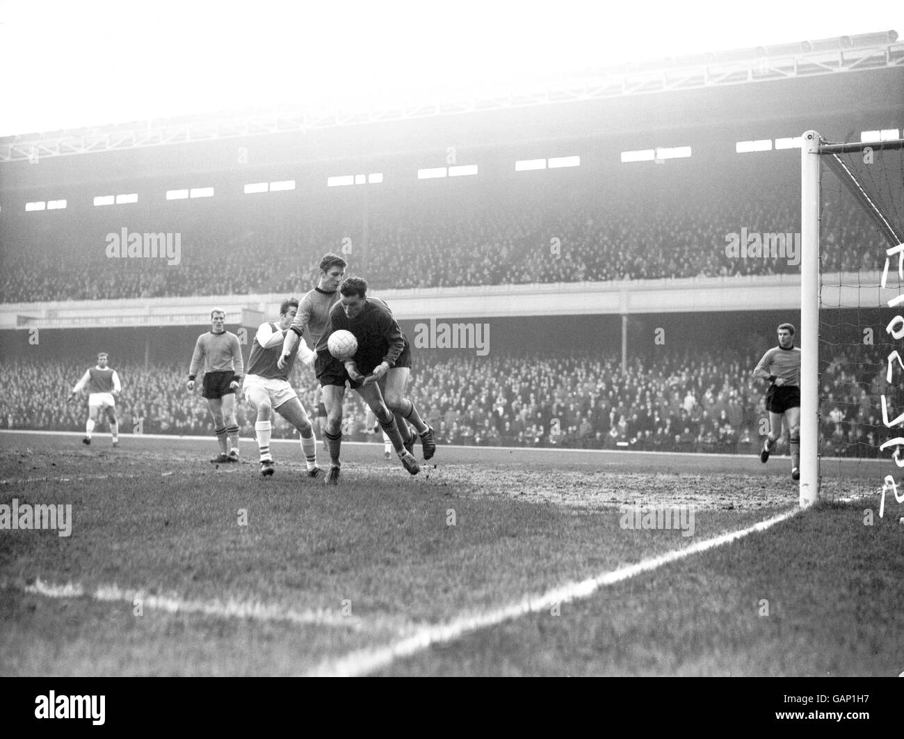 Wolverhampton Wanderers goalkeeper Dave McLaren (c, r) gathers the ball ...
