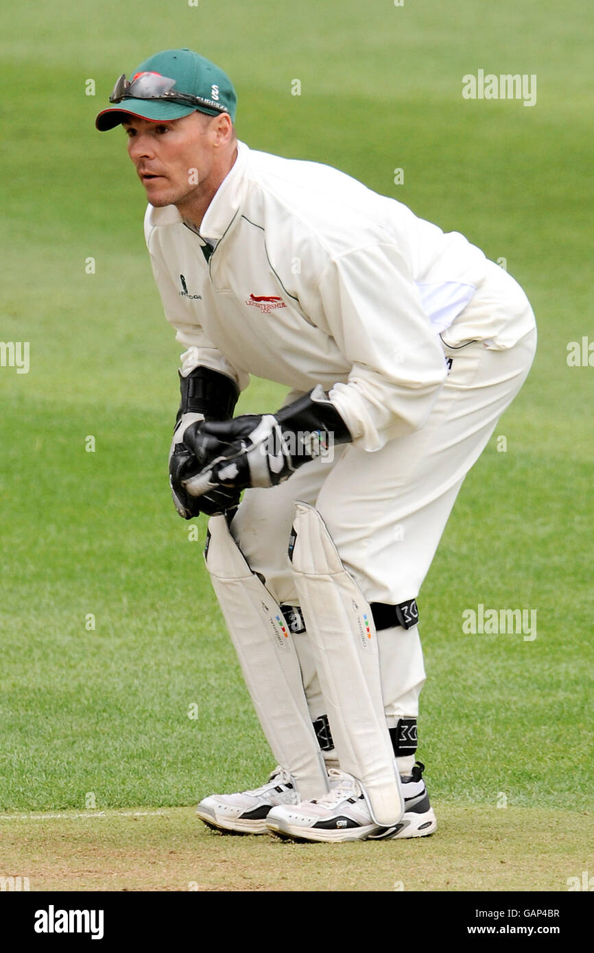 Cricket bent over full length cap gloves hi-res stock photography and ...
