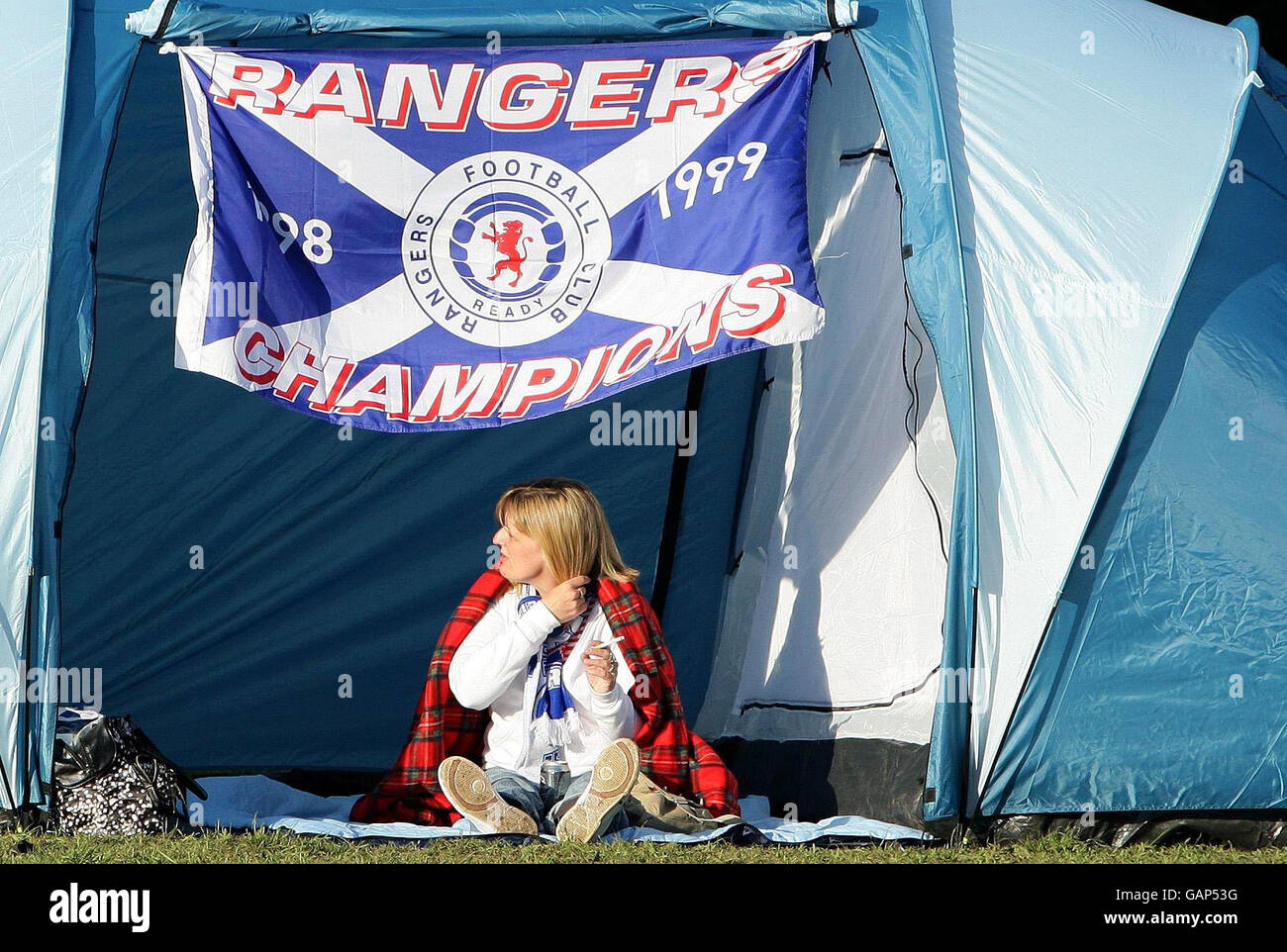 A Rangers fan wakes up after camping overnight with fellow supporters ...