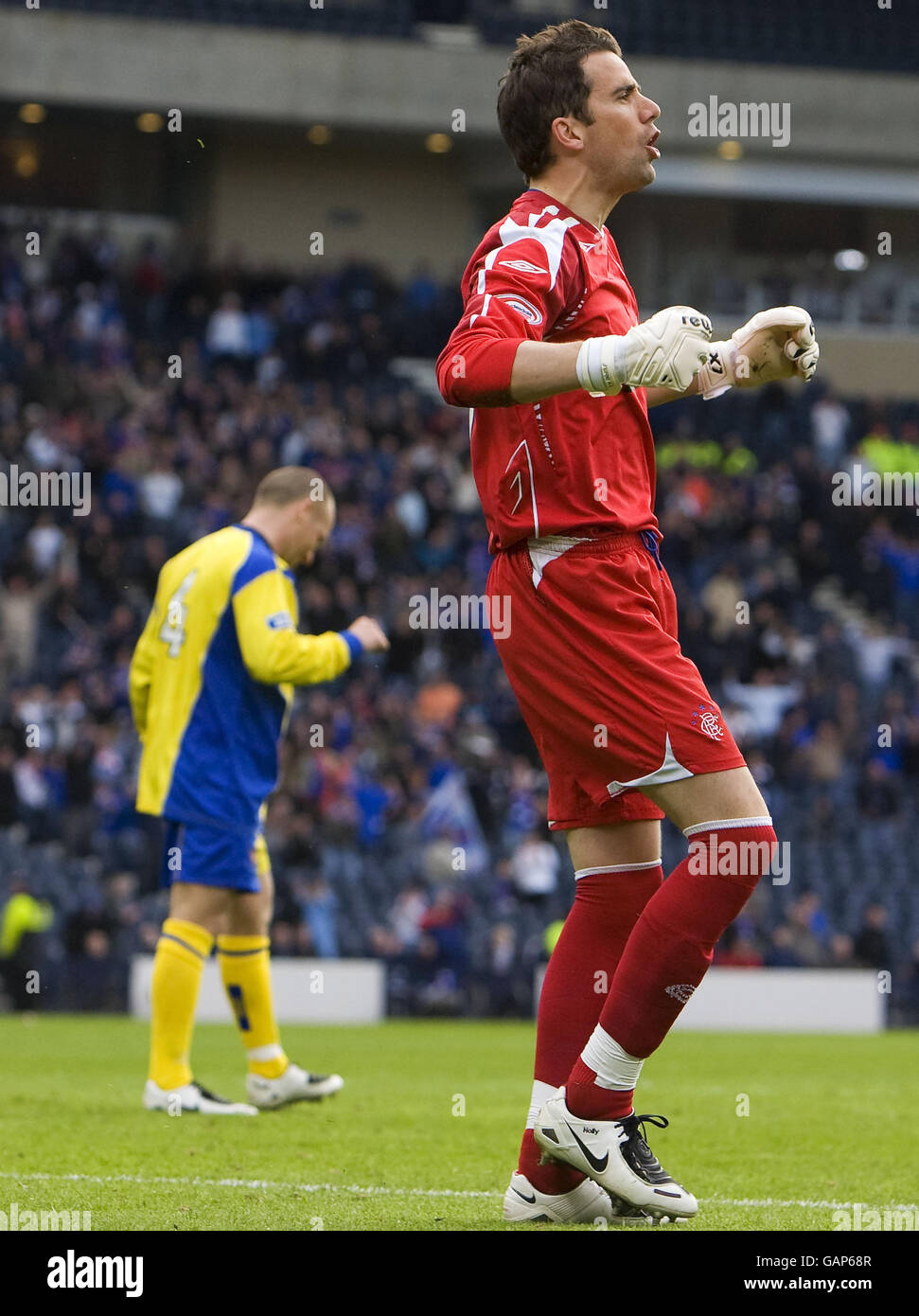 Rangers' goalkeeper Neil Alexander celebrates after saving a penalty ...