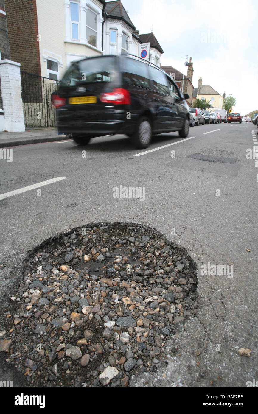 Pothole in road Stock Photo - Alamy