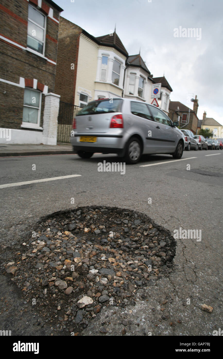 Pothole in road. A pothole in a road in Tooting, SW London Stock Photo ...