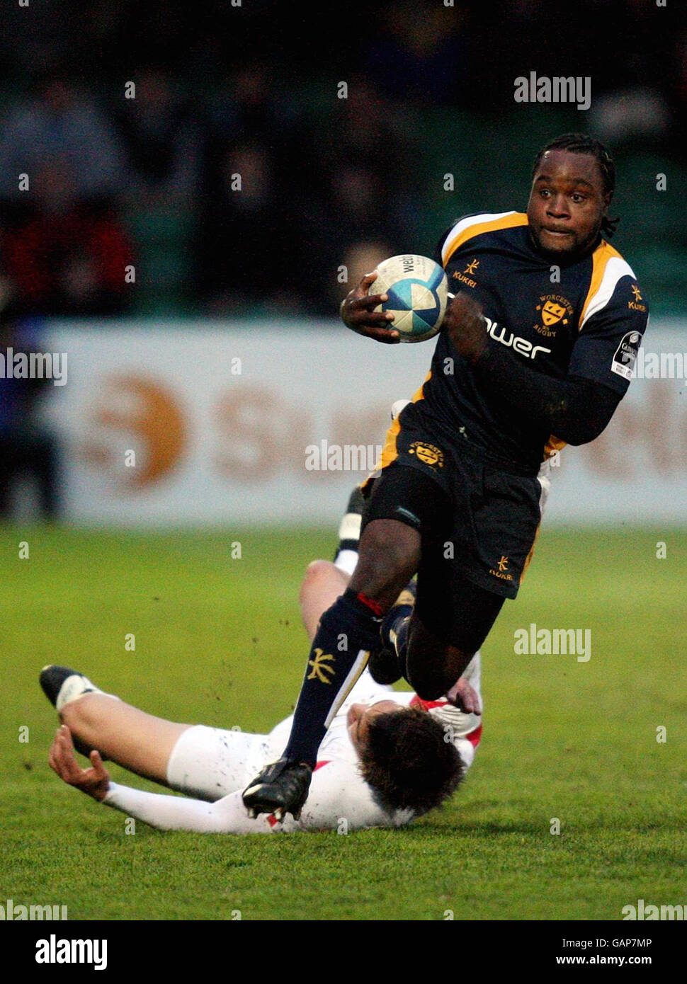 Worcester's Marcel Garvey beats the tackle of Newcastle's Toby Flood to ...