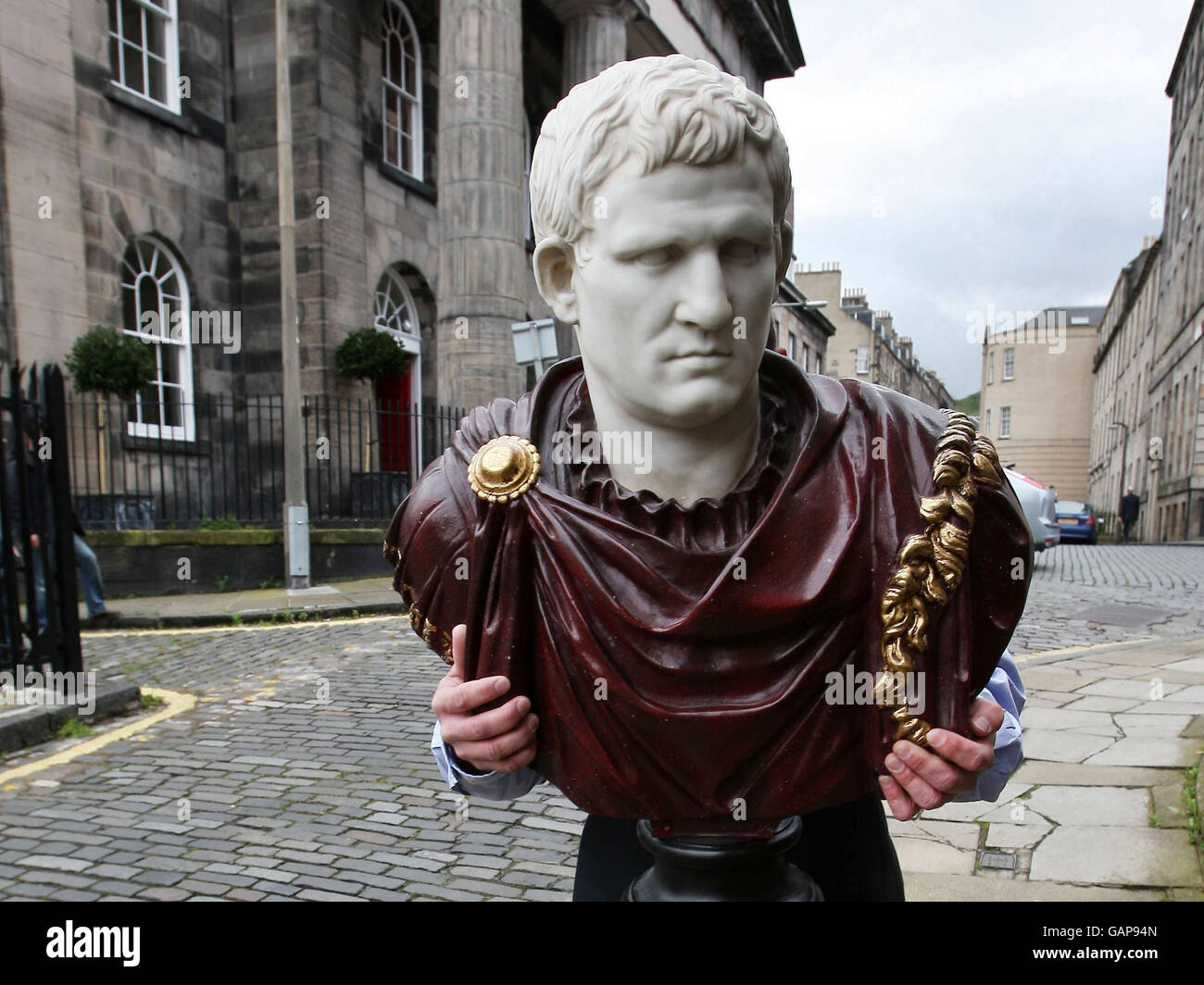 A member of Lyon & Turnbull staff arrives with a bust of Roman Emperor ...