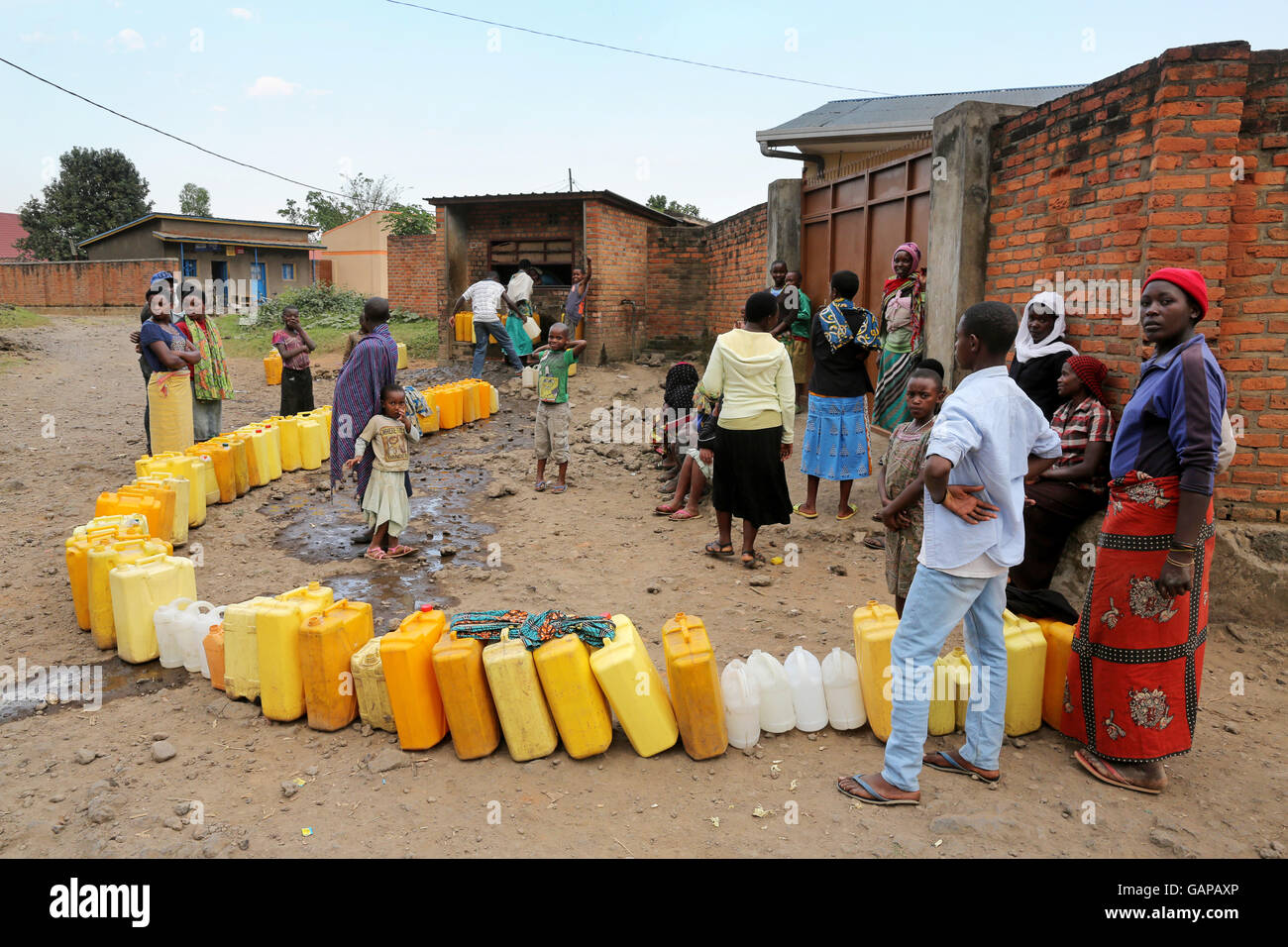 A long line of canisters waiting to be filled at a public water point ...