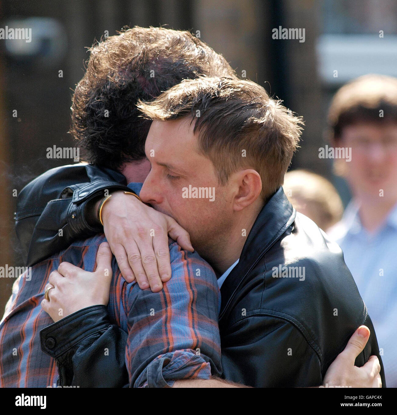 Danny, a Mizen family friend, is hugged as he leaves Our Lady of ...