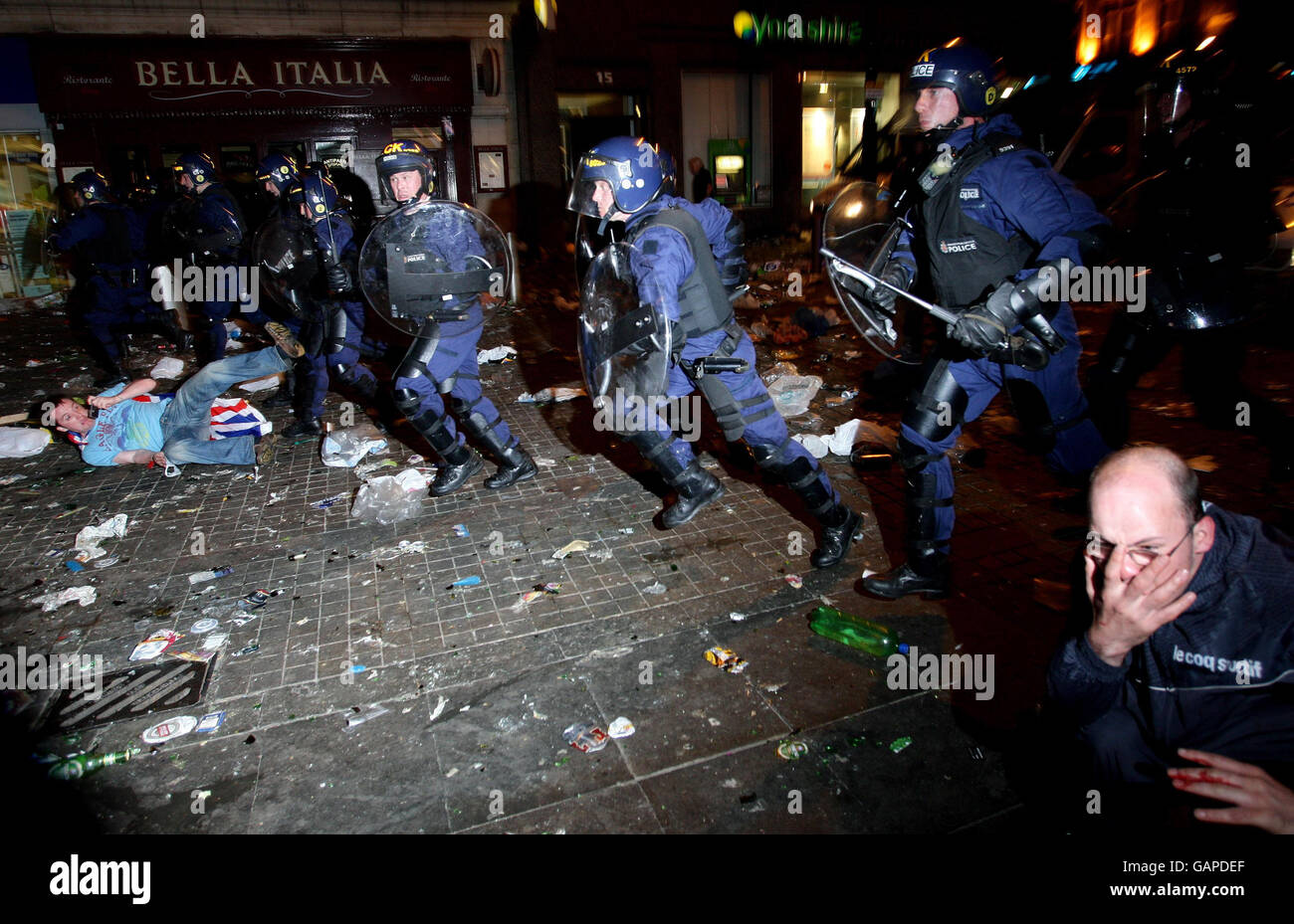Rangers fans face riot police at Manchester's Piccadilly Gardens during ...
