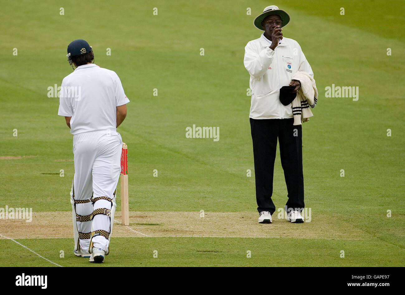 Umpire Steve Bucknor takes a light reading as England's Alastair Cook ...