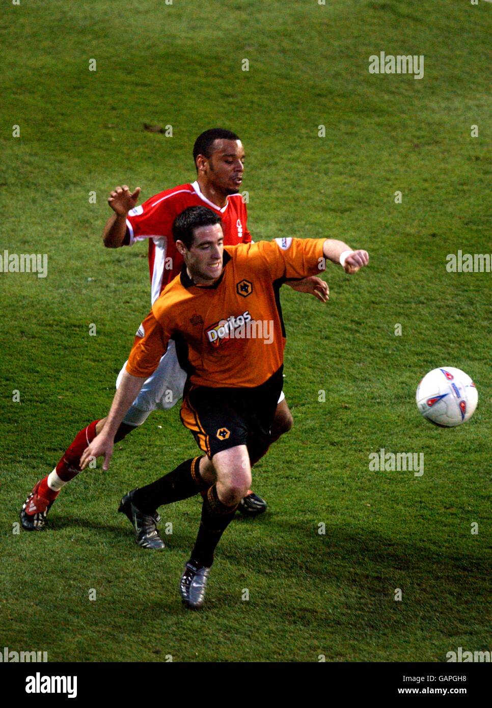Wolverhampton Wanderers' Mark Kennedy (front) shields the ball from ...