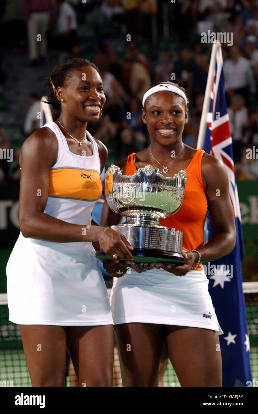 Serena Williams and Venus Williams (USA) hold the trophy after winning ...