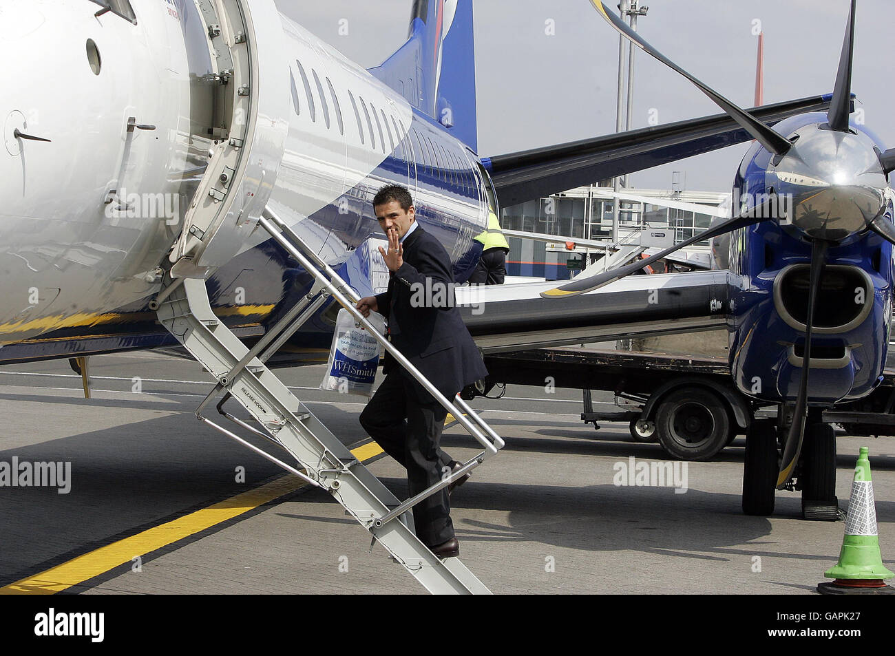 Rangers' Nacho Novo waves as he boards their plane at Glasgow Airport ...
