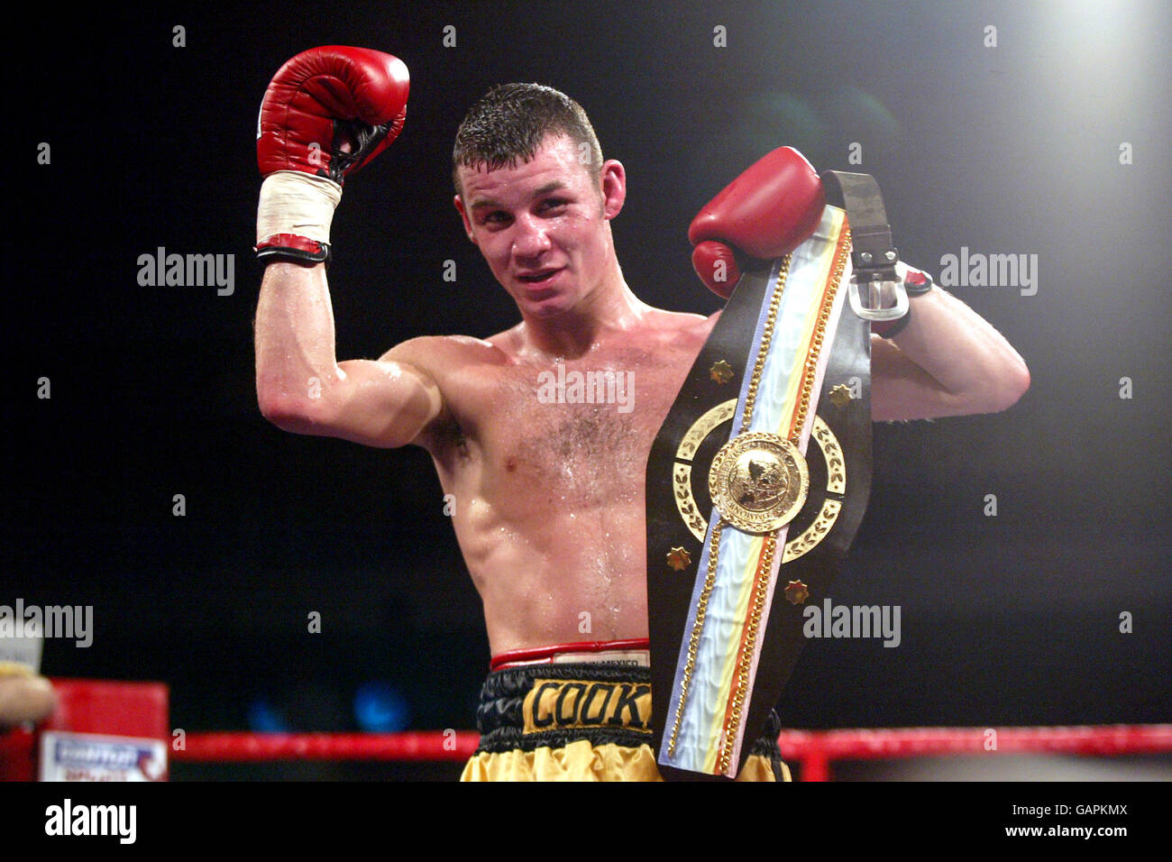 Nicky Cook holds aloft the Commonwealth Featherweight Title belt after ...