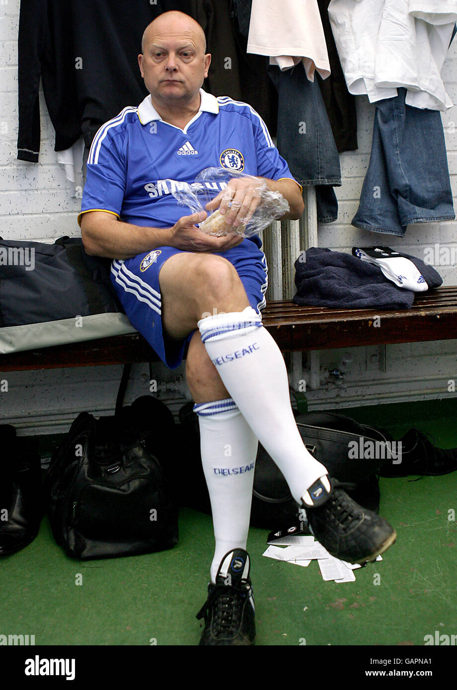 Chelsea's Graham Wilkins grabs a bite to eat in the changing rooms ...
