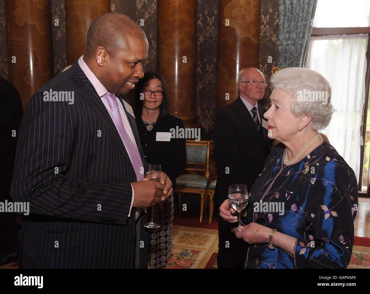 Britain's Queen Elizabeth II talks to Peregrine Stephenson of Chance UK ...