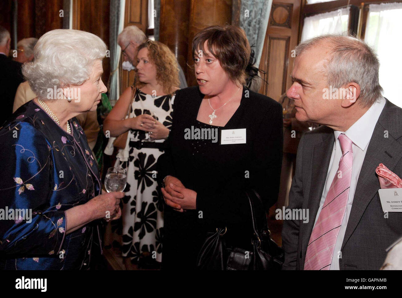 Britain's Queen Elizabeth II talks to Mrs Debra Johnson and Mr Andrew ...