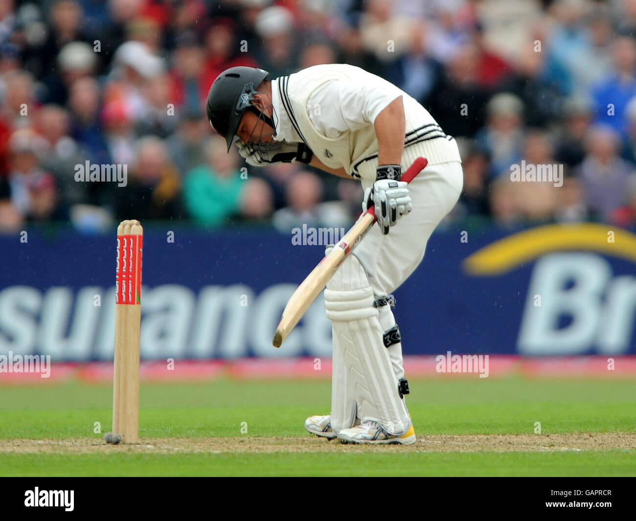 New Zealand's Daniel Flynn is hit on the head by England's James ...