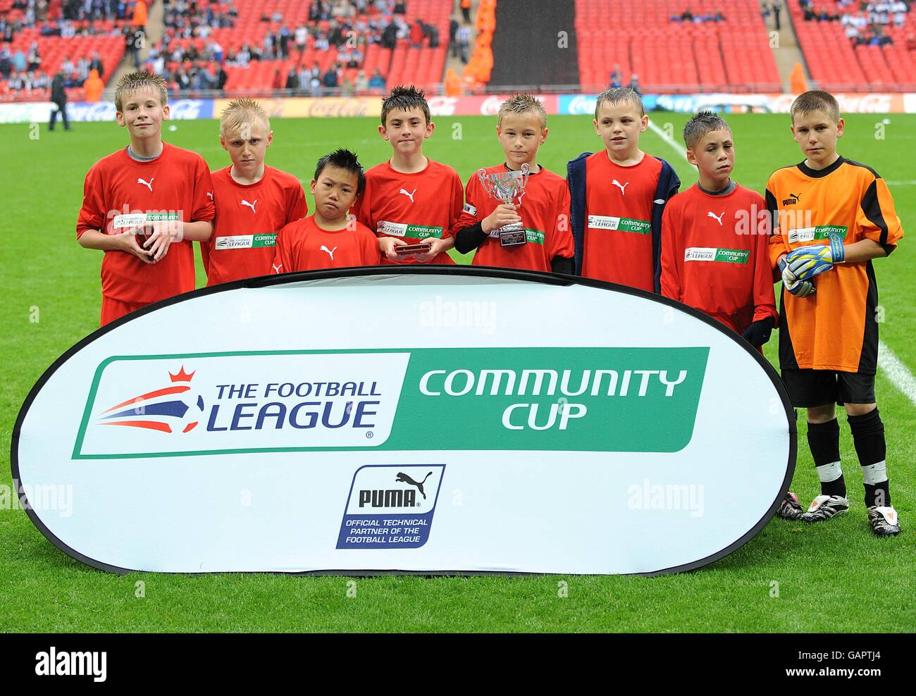 Children pose with their medals after taking part in the Community Cup ...