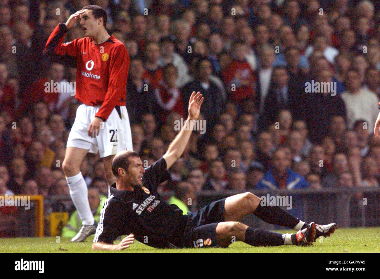 Real Madrid's Zinedine Zidane (on floor) pleads for a free kick as ...
