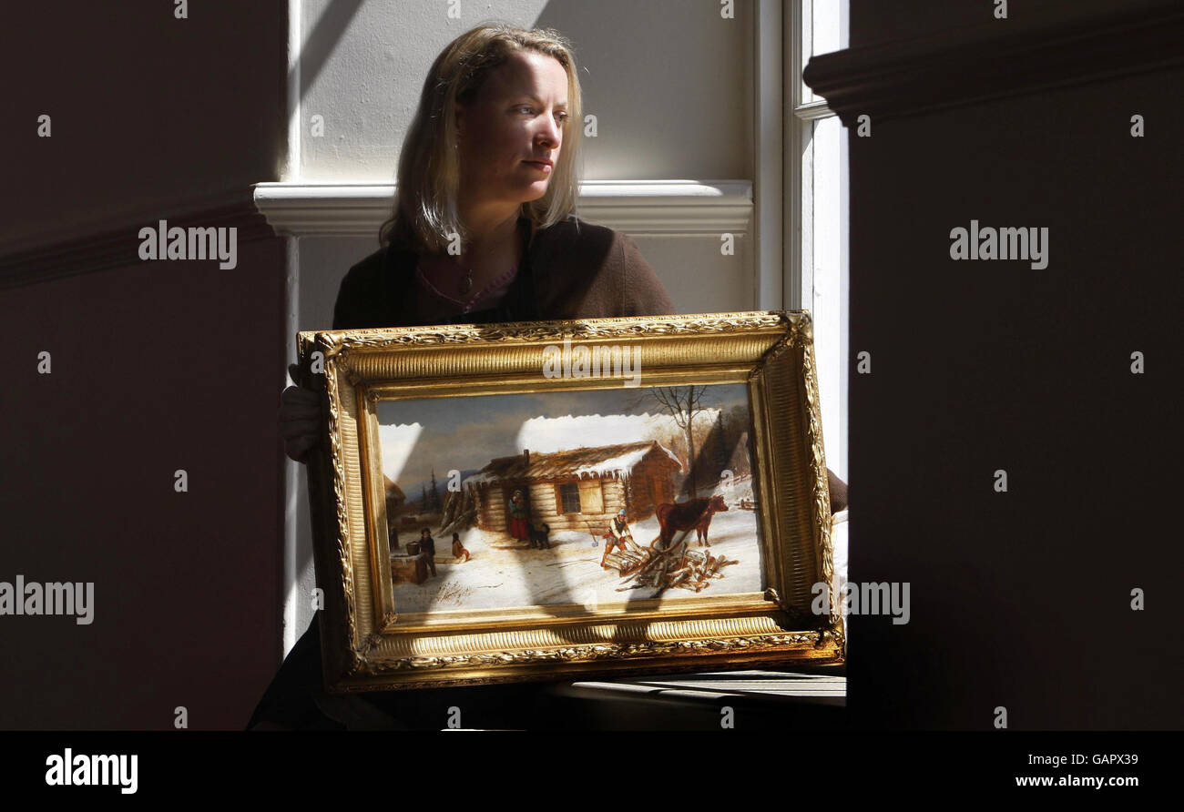 Lyon and Turnbull employee Sarah Russell holds a painting titled ...