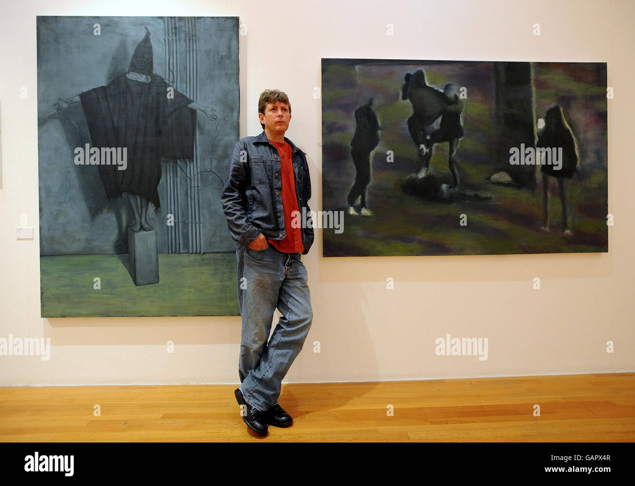 Fine artist David Sullivan with two examples of his oil on canvas work ...