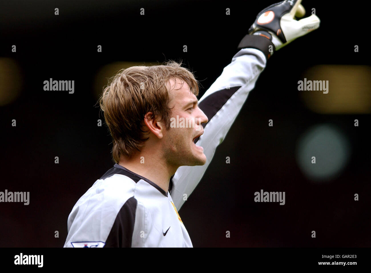 Manchester United's goalkeeper Roy Carroll points the way forward to ...