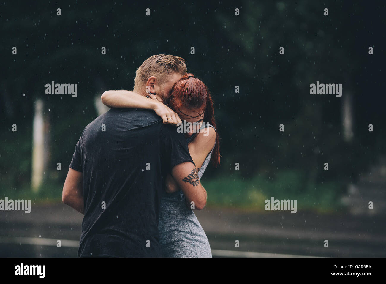 beautiful couple hugging in the rain Stock Photo - Alamy