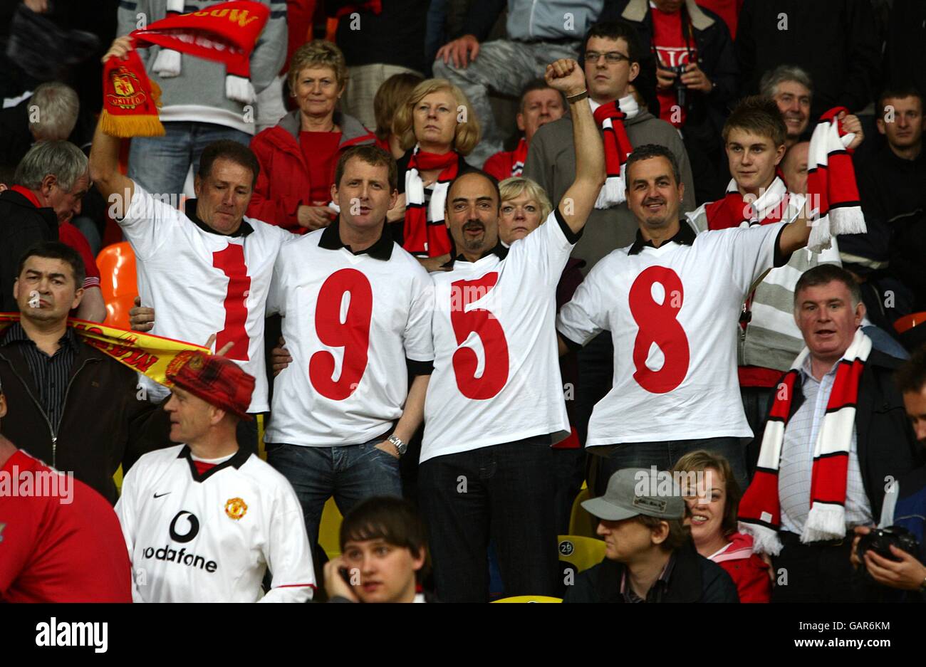 Manchester united fans cheer on their side in the stands hi-res stock ...