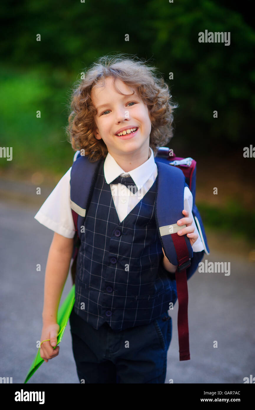 Cute little first grader goes to school. The primary school students ...