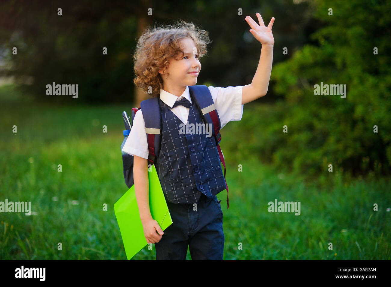 Curly blond student goes to school. The primary school students smartly ...