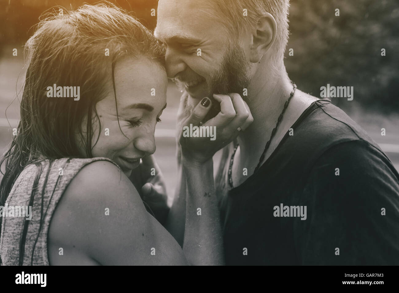beautiful couple hugging in the rain Stock Photo - Alamy