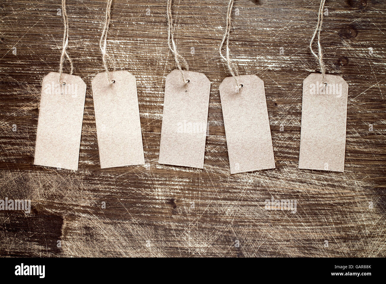 blank tags on the wooden background with copy-space Stock Photo - Alamy