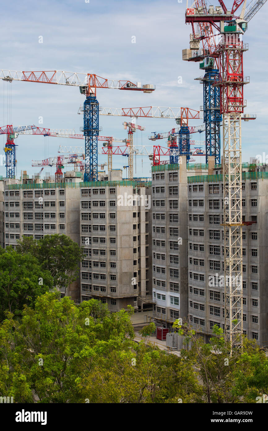 Vertical image of Tower cranes at construction site in the industrial ...