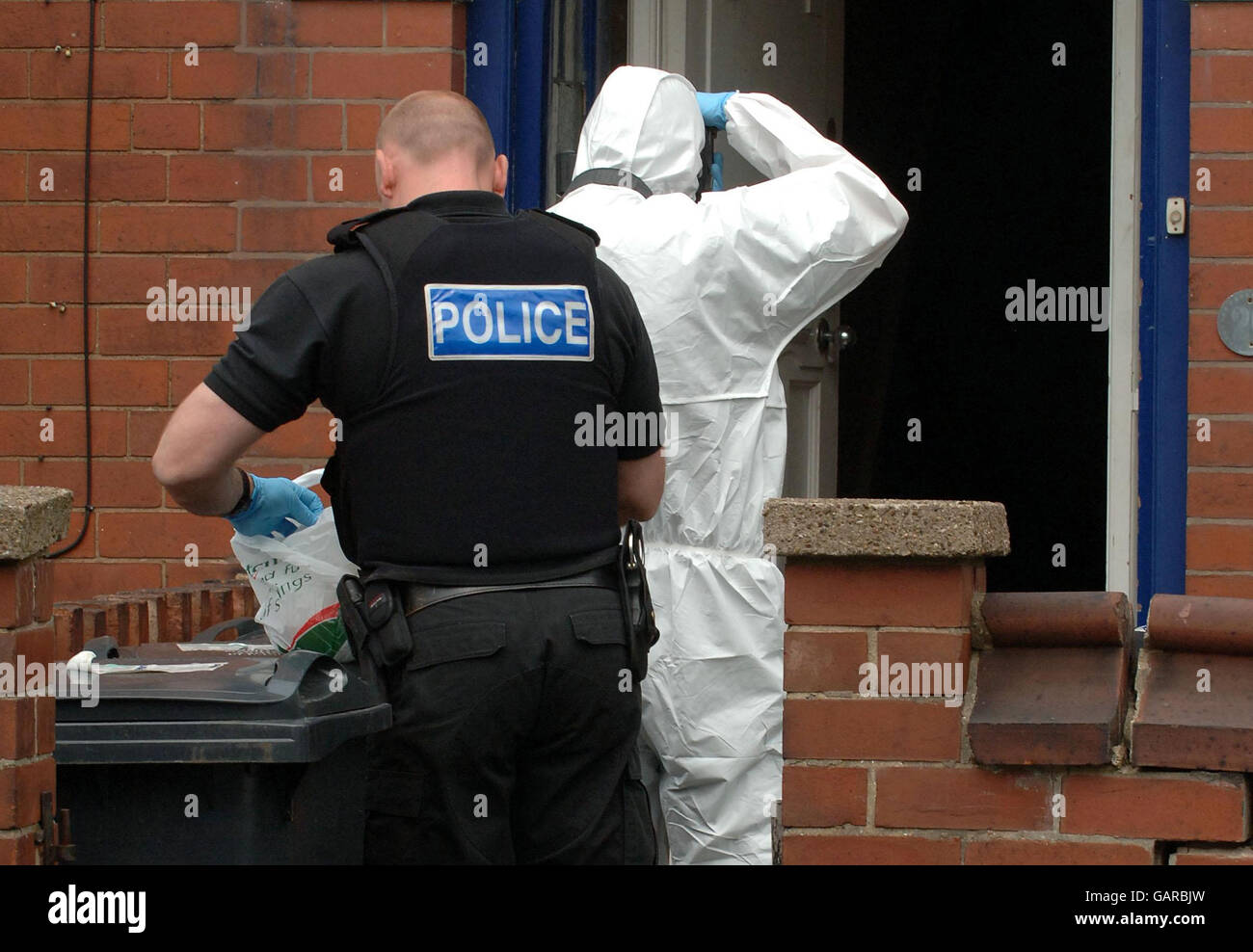 Police officers outside a house on Bainbridge Road, Balby, Doncaster ...