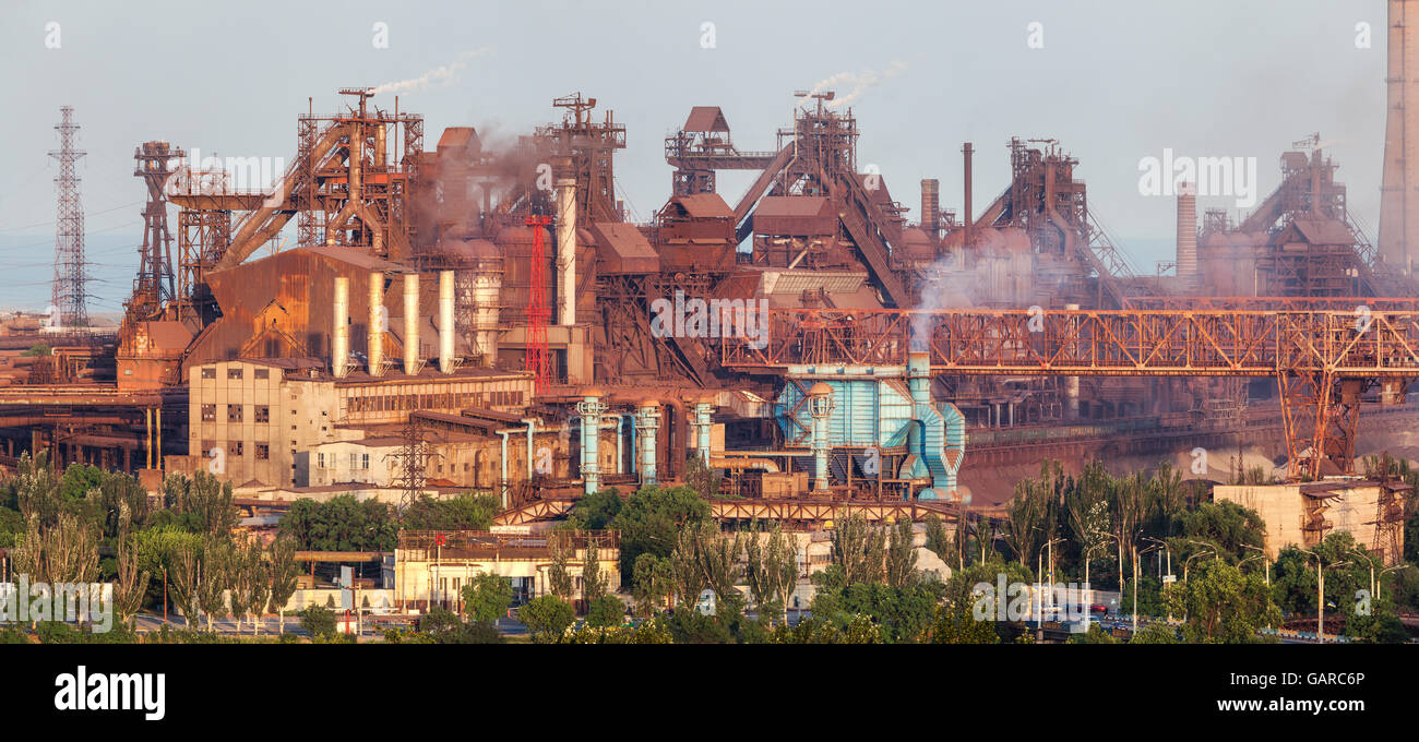 Rusty steel factory with smokestacks at sunset. metallurgical plant ...