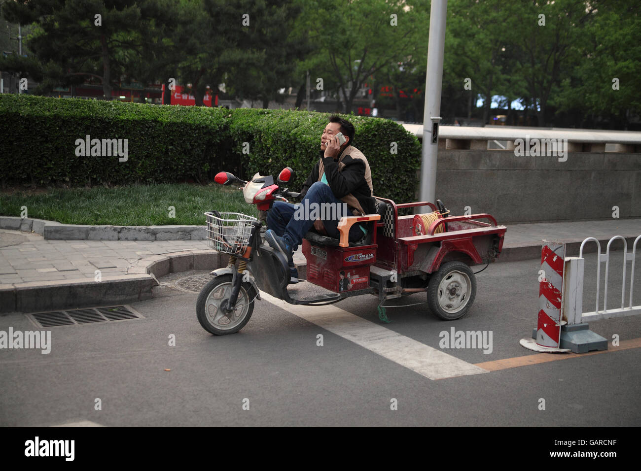 Man riding tricycle on street hi-res stock photography and images - Alamy